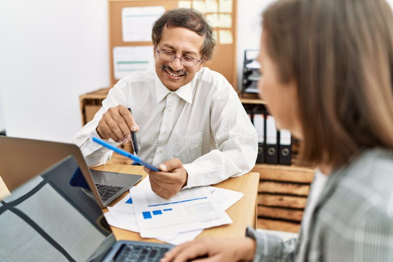 Middle Age Man and Woman Business Workers Using Touchpad Working at ...
