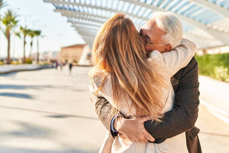 Middle Age Man And Woman Couple Hugging Each Other Standing At Park