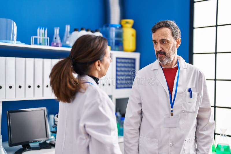 Middle Age Man and Woman Scientists Standing Together at Laboratory ...