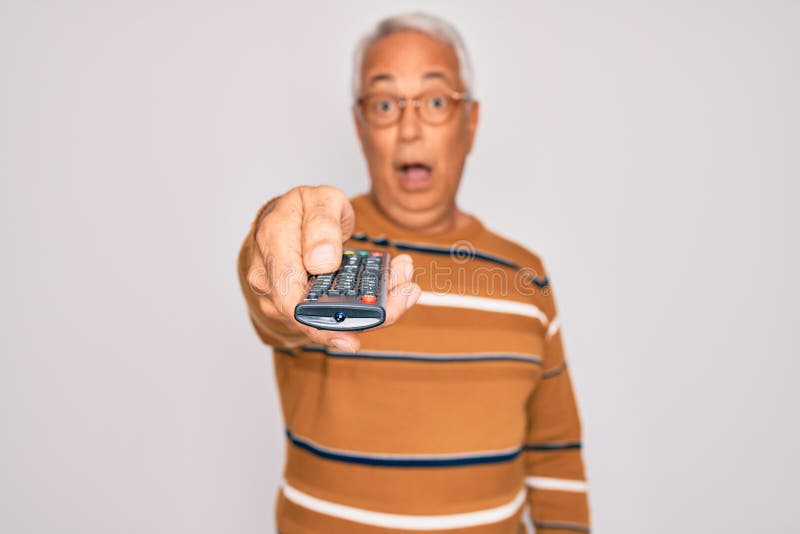Middle Age Senior Grey-haired Man Using Tv Remote Control Watching ...