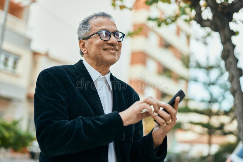 Middle Age Southeast Asian Man Smiling Using Smartphone at the City ...