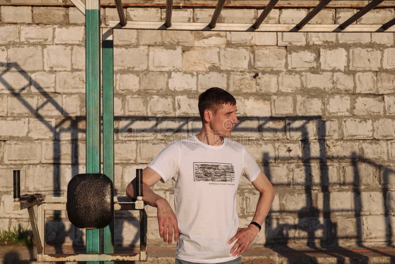 Middle Age Sportsman is Standing Near the Horizontal Bar and Parallel ...