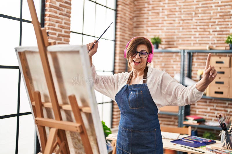 Middle Age Woman Artist Drawing and Dancing at Art Studio Stock Photo ...