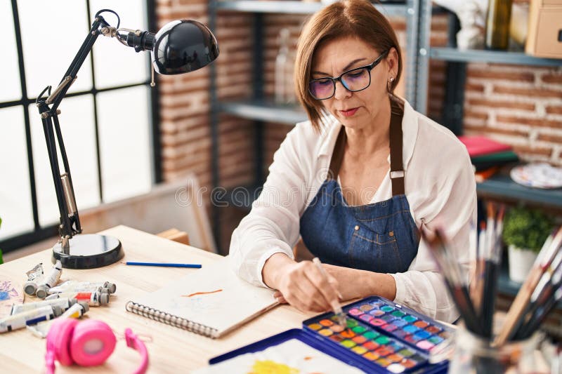 Middle Age Woman Artist Drawing on Notebook at Art Studio Stock Photo ...