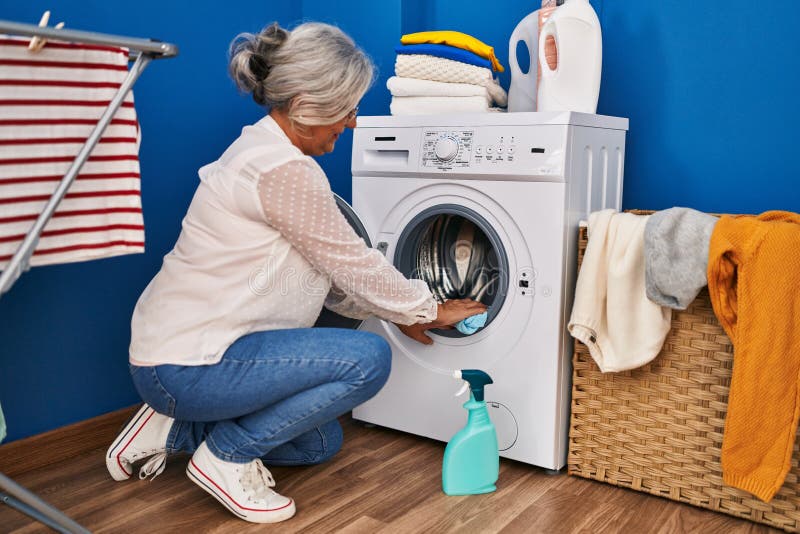 Middle Age Woman Cleaning Washing Machine at Laundry Room Stock Image ...