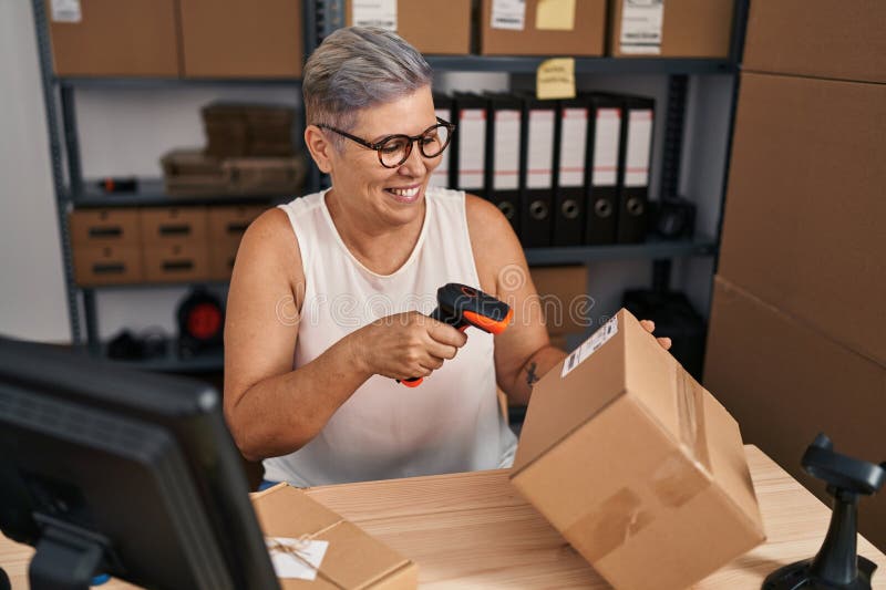 Middle Age Woman Ecommerce Business Worker Scanning Package at Office ...