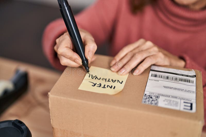 Middle Age Woman Ecommerce Business Worker Writing on Package at Office ...