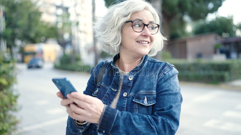 Middle Age Woman with Grey Hair Using Smartphone at Park Stock Photo ...