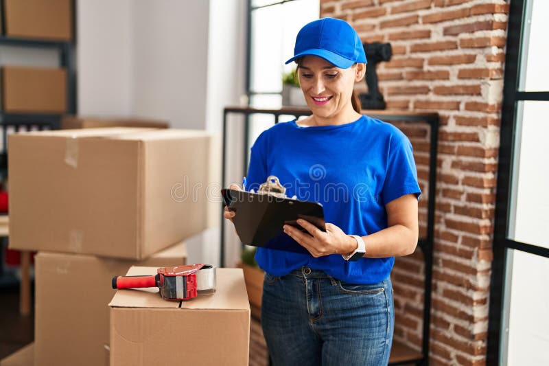Middle Age Woman Moving Worker Writing on Checklist at New Home Stock ...