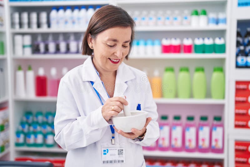 Middle Age Woman Pharmacist Smiling Confident Make Mixture at Pharmacy ...