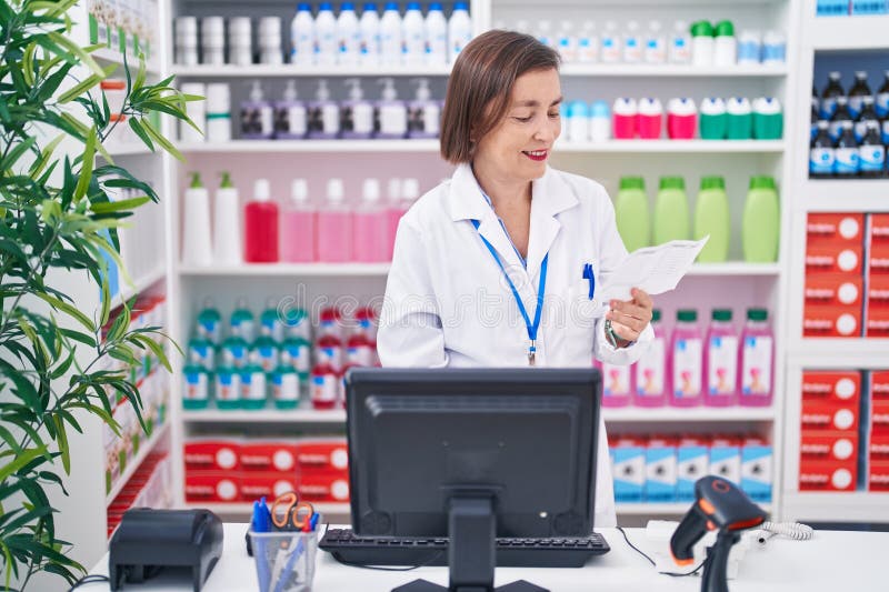 Middle Age Woman Pharmacist Using Computer Reading Prescription at ...