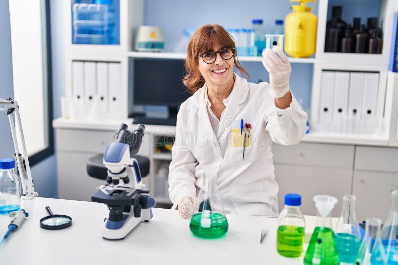 Middle Age Woman Scientist Smiling Confident Looking Sample at ...
