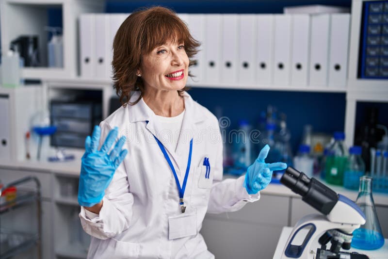 Middle Age Woman Scientist Smiling Confident Speaking at Laboratory ...