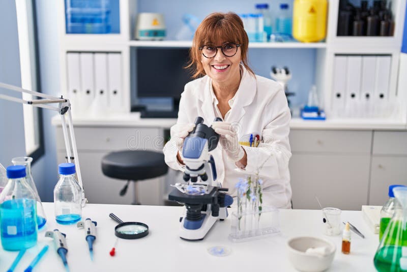 Middle Age Woman Scientist Smiling Confident Using Microscope at ...