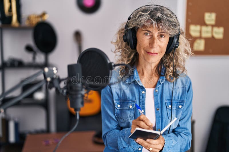 Middle Age Woman Singer Composing Song at Music Studio Stock Photo ...