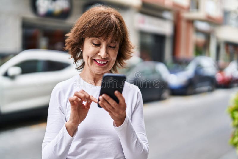 Middle Age Woman Smiling Confident Using Smartphone at Street Stock ...