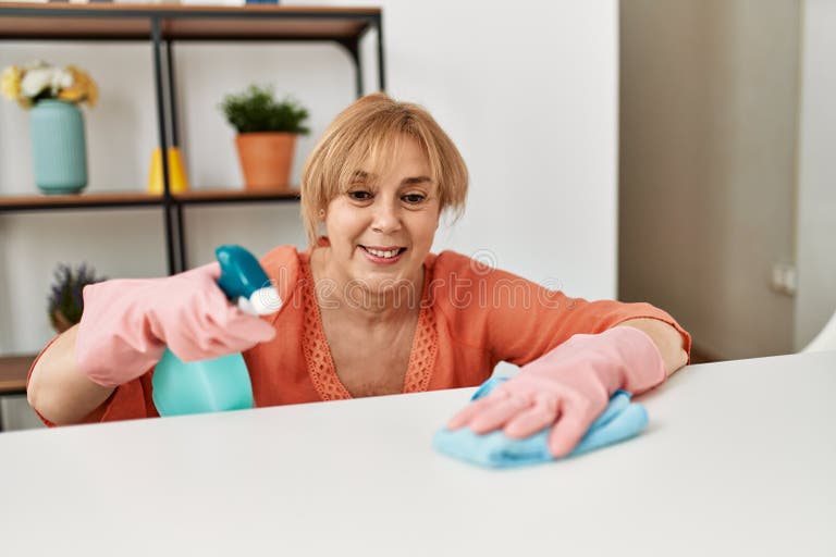 Middle Age Woman Smiling Happy Cleaning Using Diffuser and Rag at Home ...