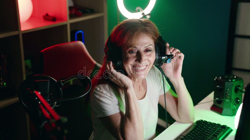 Middle Age Woman Streamer Playing Video Game Using Computer at Gaming ...