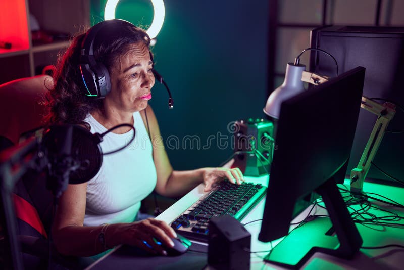 Middle Age Woman Streamer Playing Video Game Using Computer at Gaming ...