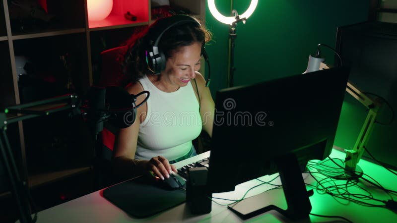 Middle Age Woman Streamer Playing Video Game Using Computer at Gaming ...