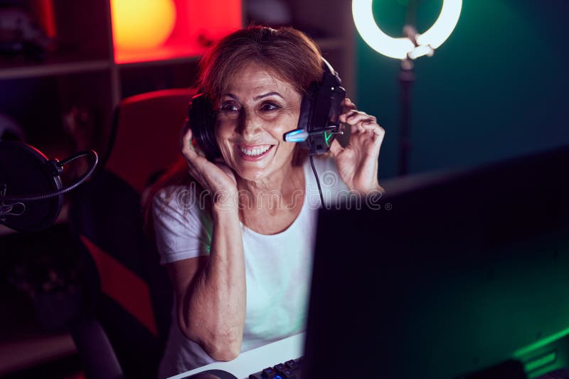 Middle Age Woman Streamer Playing Video Game Using Computer at Gaming ...