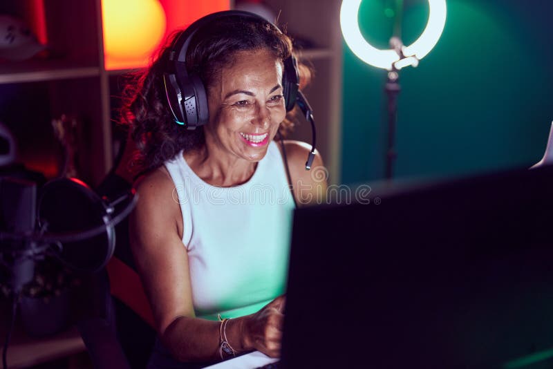 Middle Age Woman Streamer Playing Video Game Using Computer at Gaming ...