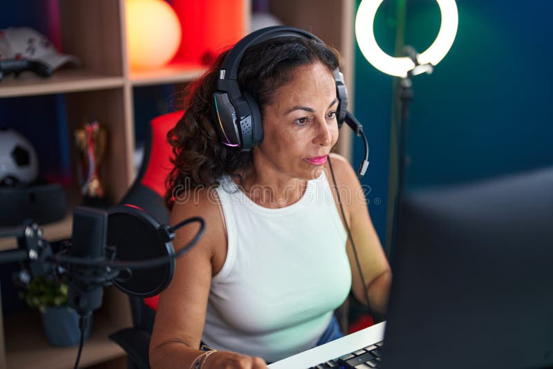 Middle Age Woman Streamer Playing Video Game Using Computer at Gaming ...