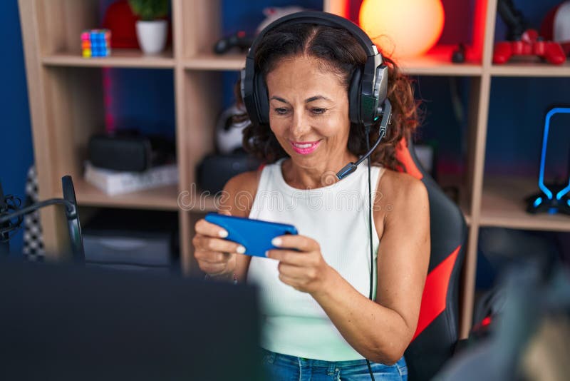 Middle Age Woman Streamer Playing Video Game Using Smartphone at Gaming ...
