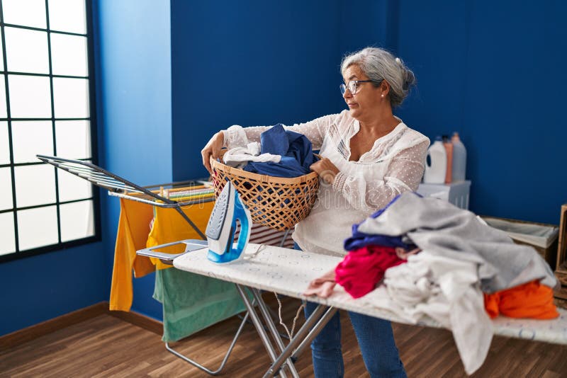Middle Age Woman Stressed Doing Chores at Laundry Room Stock Photo ...