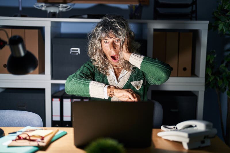 Middle Age Woman Working at Night Using Computer Laptop Looking at the ...