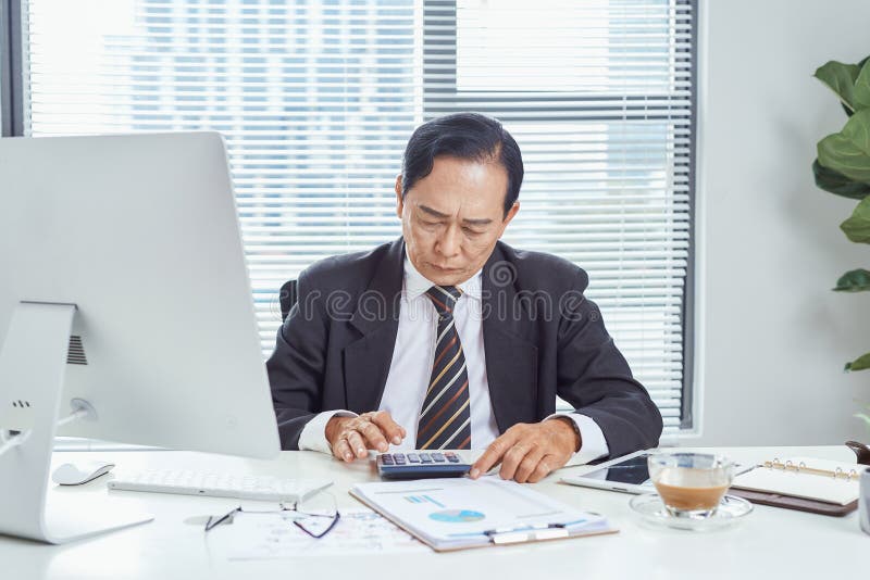 Middle Aged Asian Businessman Feeling Stressed And Frustrated While
