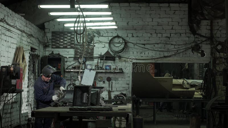 Middle-aged Blacksmith Man Works in His Forge with a Hammer Stock ...