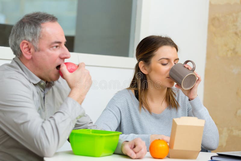 Middle Aged Business Colleagues Eating in Office Stock Image - Image of ...