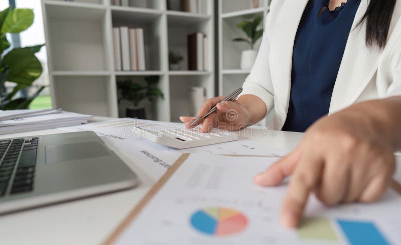 Middle-aged Business Woman Doing Paperwork and Working on Computer in ...