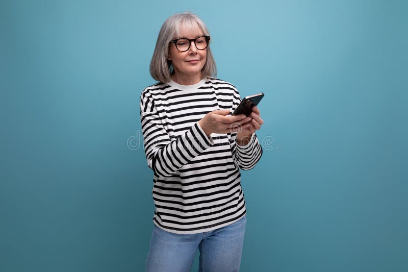 Middle Aged Business Woman Surfs the Internet Using Smartphone on ...
