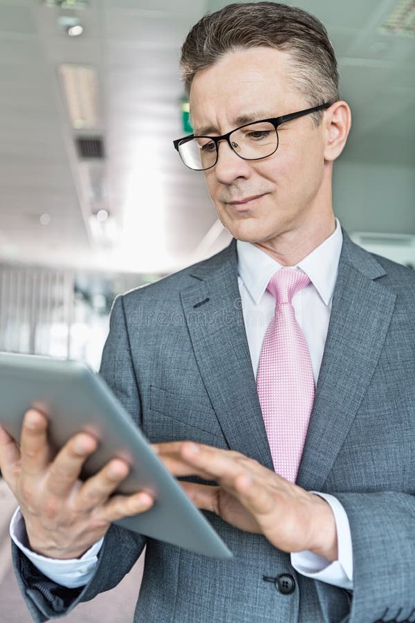 Middle-aged Businessman Using Tablet PC in Office Stock Photo - Image ...