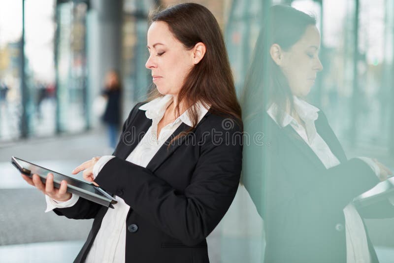 Middle-aged Businesswoman Using Internet on Tablet Computer Stock Image ...