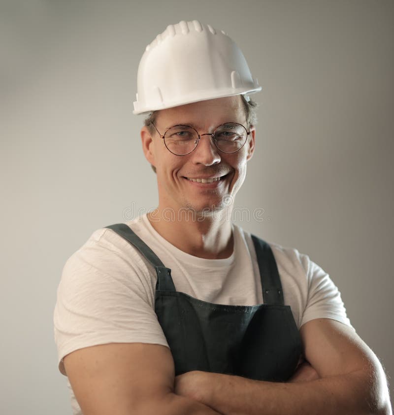 Middle-aged Carpenter Wearing a White Hard Hat and Uniform Against a ...