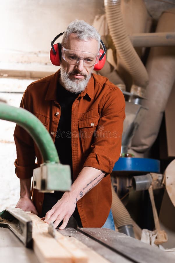 Middle Aged Carpenter Working on Blurred Stock Image - Image of work ...