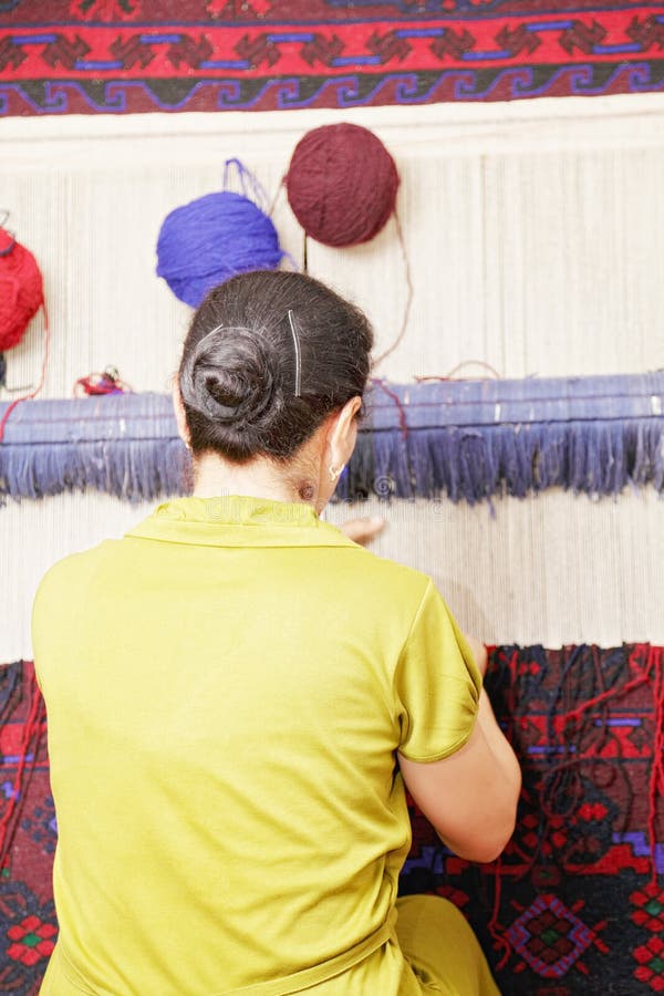 Middle-aged carpet weaver stock image. Image of rear - 28733529