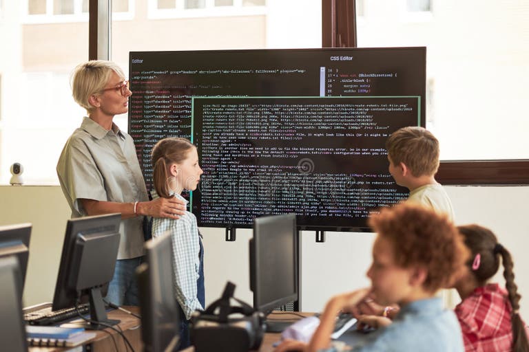 Middle Aged Caucasian Woman Teaching Diverse Children Coding in ...