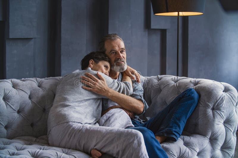 Couple Hugging while Sitting on the Couch Stock Image - Image of adults ...