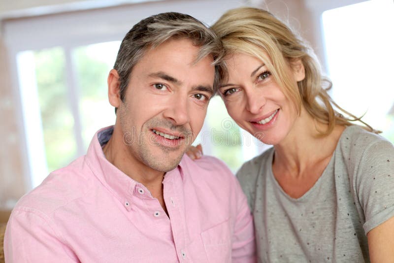 Middle-aged couple in love stock photo. Image of indoors - 65075556