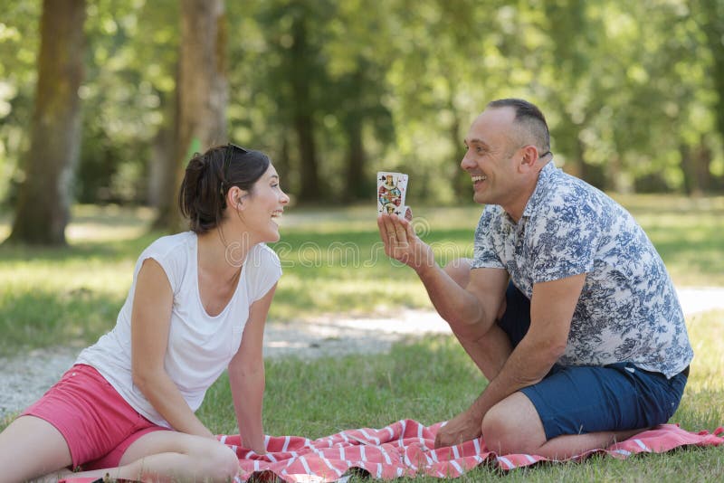 Middle-aged Couple Playing Cards Outdoors Stock Photo - Image of summer ...