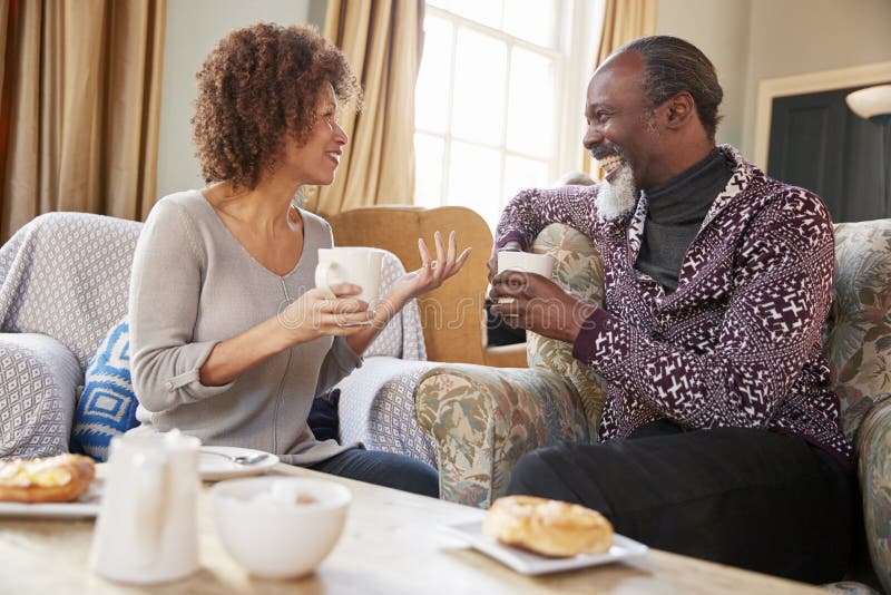 Middle Aged Couple Sitting Around Table in Coffee Shop Stock Image ...