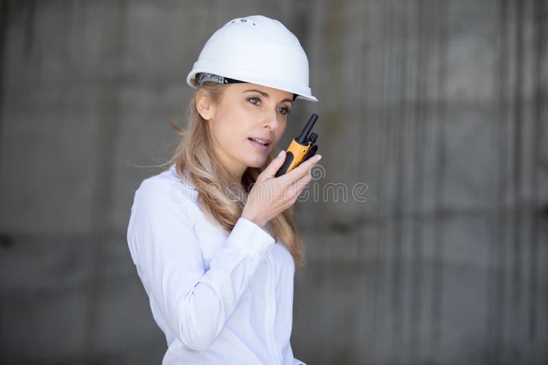 Middle Aged Engineer in Hard Hat Using Walkie-talkie while Working ...