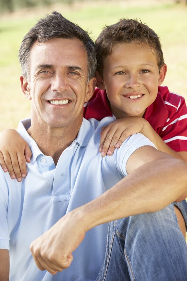 Middle Aged Father and Son Relaxing in Countryside Stock Image - Image ...