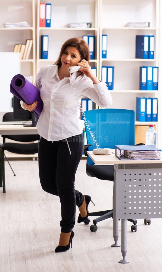 Middle-aged Female Employee Doing Exercises in the Office Stock Image ...