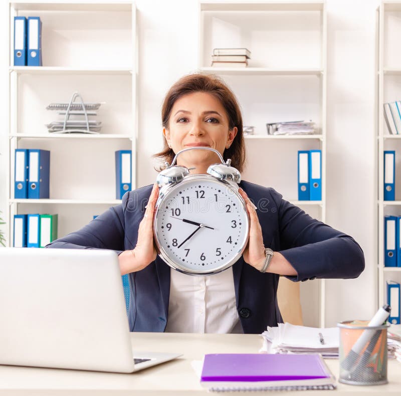 Middle-aged Female Employee Sitting at the Office Stock Photo - Image ...