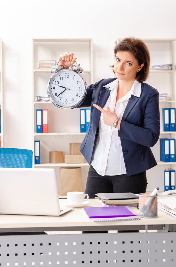 The Middle-aged Female Employee Sitting at the Office Stock Photo ... The Middle-aged Female Employee Sitting at the Office Stock Photo ...
